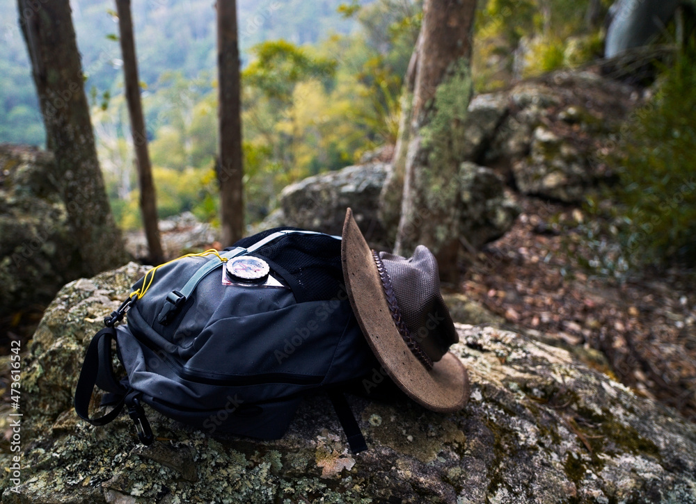 Compass, backpack and Australian akubra hat resting on a rock in the ...