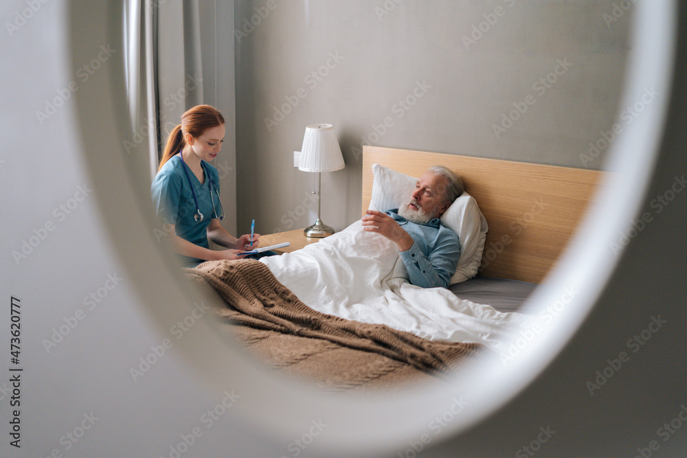 Reflection on mirror of female doctor writing down diagnosis and ...