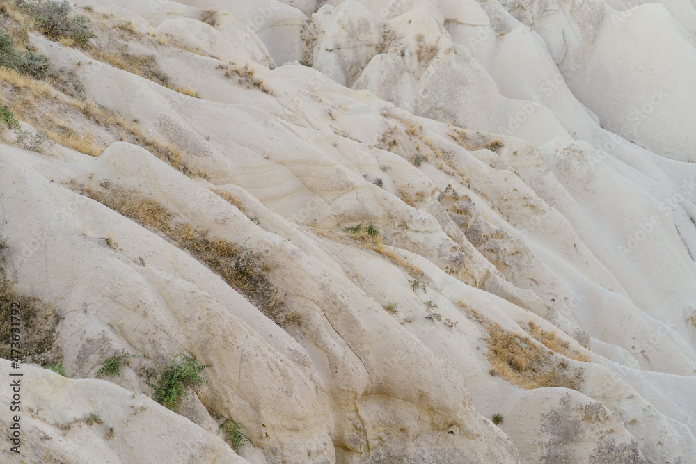 Texture of a mountain sandy rock from a yellow friable old rotten stone ...