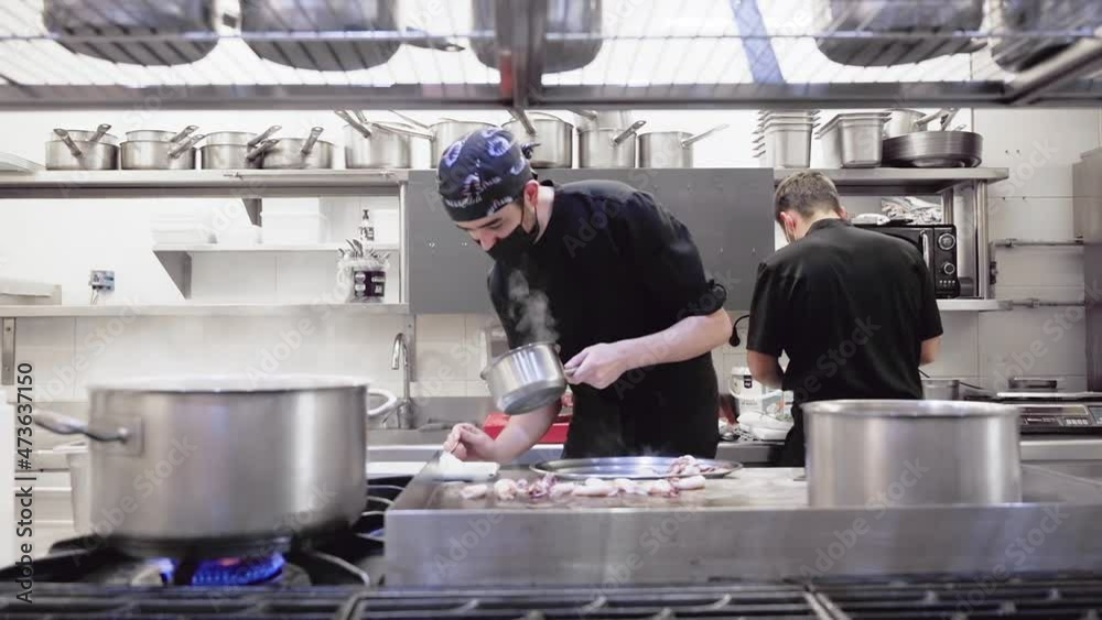 Diverse group of chefs preparing food in restaurant kitchen. Working in ...