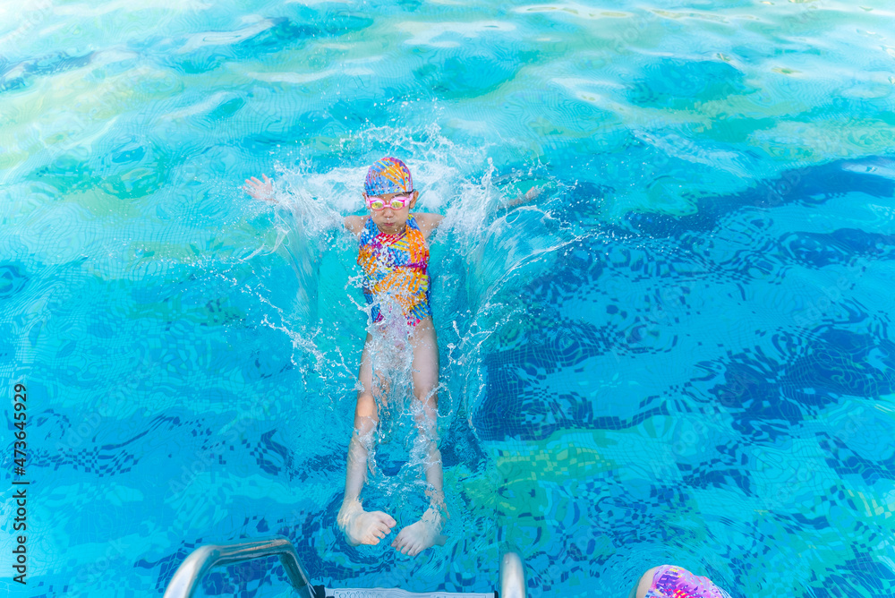 kid jumping in swimming pool Stock Photo | Adobe Stock