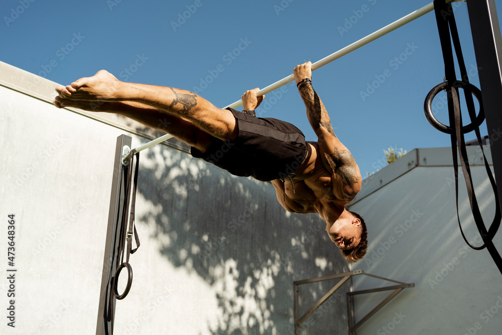 Man doing back lever Calisthenics pose Stock Photo | Adobe Stock