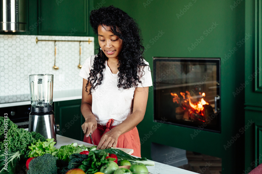 Black woman cooking vegan food Stock Photo | Adobe Stock