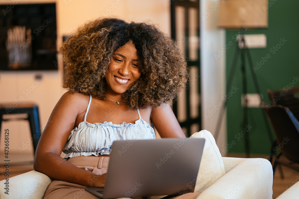 Black woman working on laptop Stock Photo | Adobe Stock