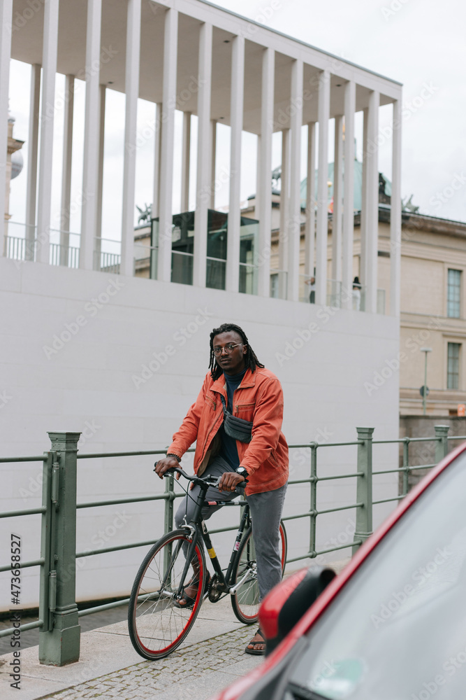 Full-length portrait of a man riding a bicycle Stock Photo | Adobe Stock