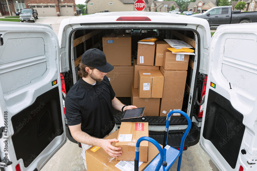Shipment: Man Getting Boxes Out Of Delivery Van Stock Photo | Adobe Stock