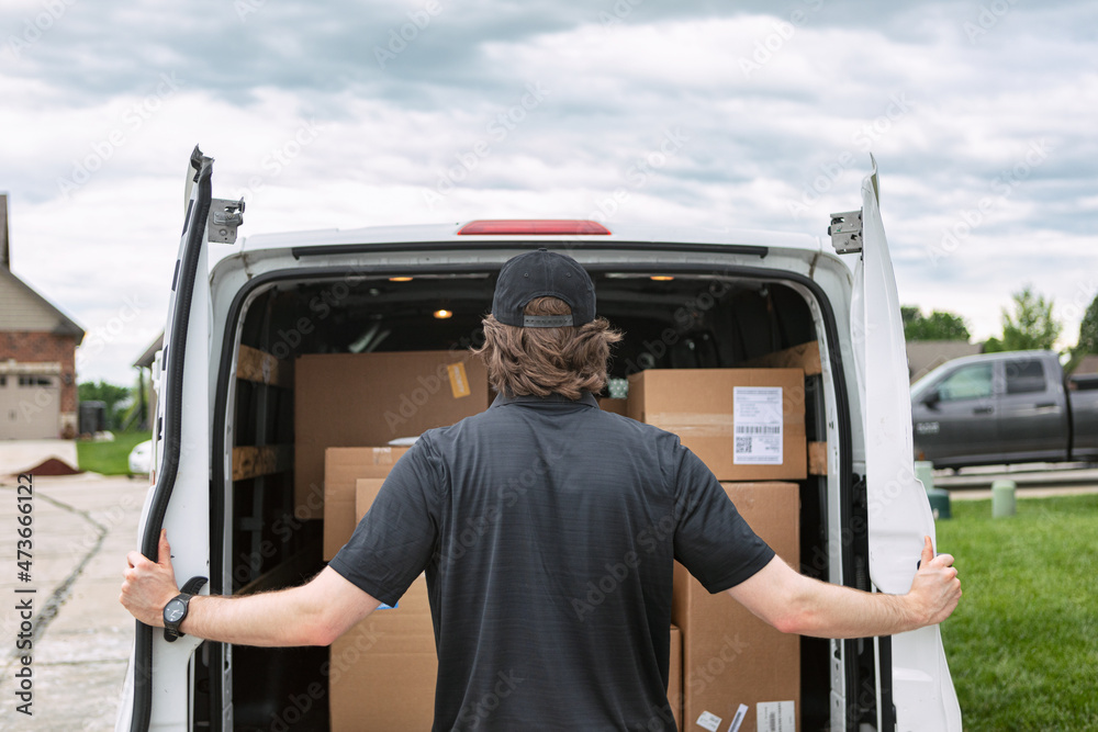 Shipment: Man Opens Rear Doors Of Delivery Van Stock Photo | Adobe Stock