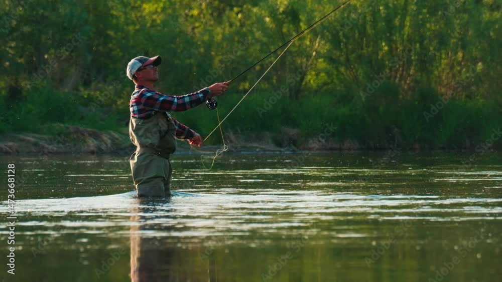 Fly fishing. Man fly fishing on the wild river with lots of insects ...
