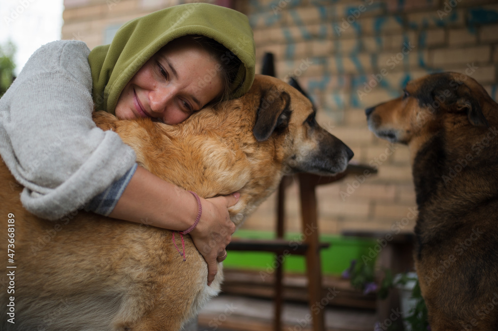cute portrait of a young woman hugging her dog Stock Photo | Adobe Stock