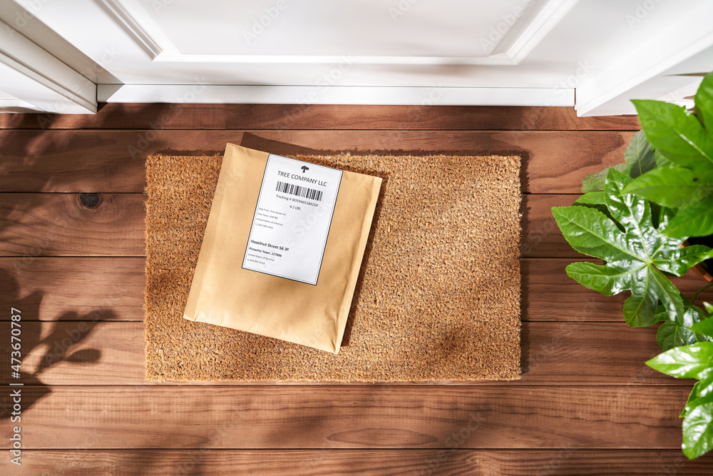 Delivered parcel bag outside entry door Stock Photo | Adobe Stock