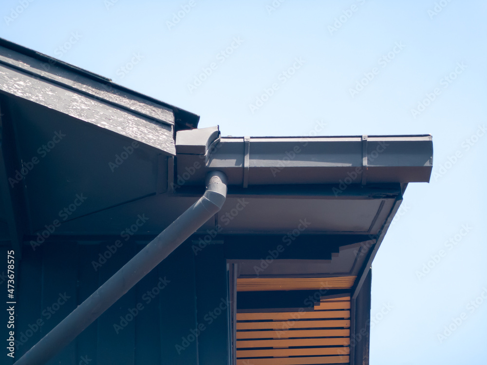 Low angle view, roof corner with dark gray gutter. Stock-Foto | Adobe Stock