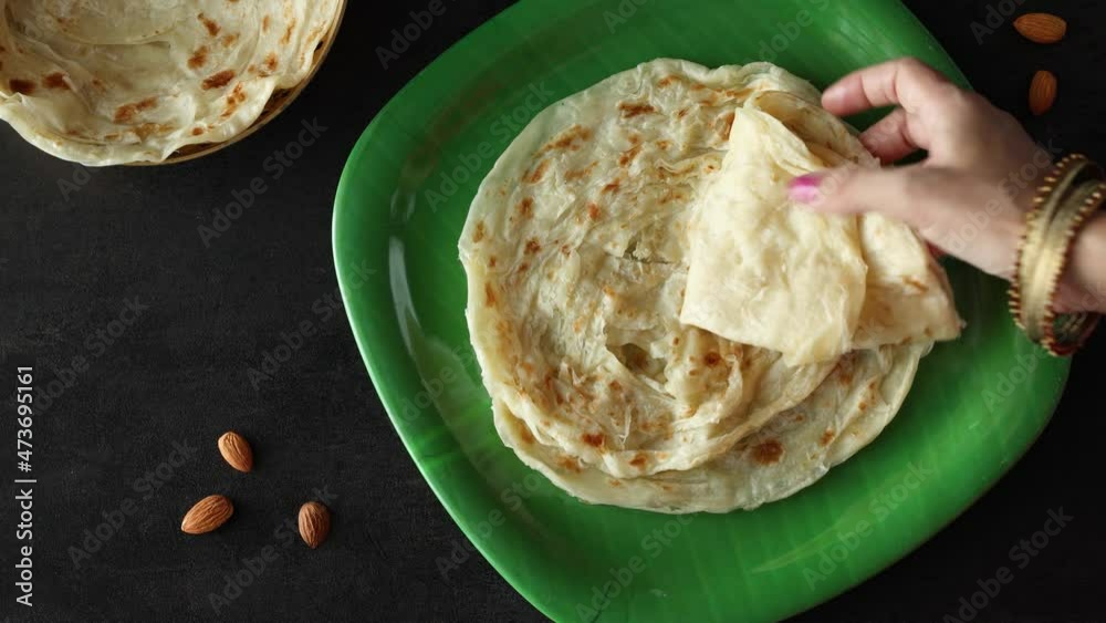 Indian flat bread Kerala porotta woman hand serving eating Malabar ...