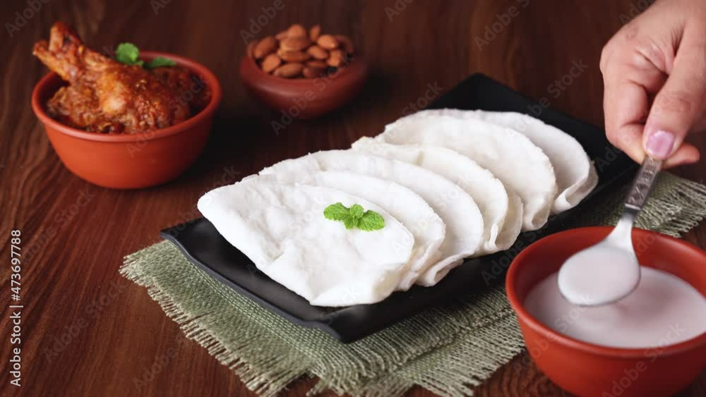 Rice Pathiri pathir flat bread spicy chicken curry woman hand serving ...