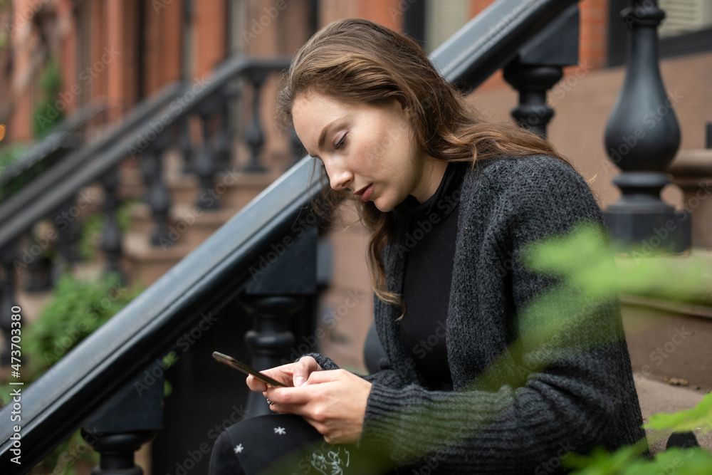 Woman on the phone outside Stock Photo | Adobe Stock