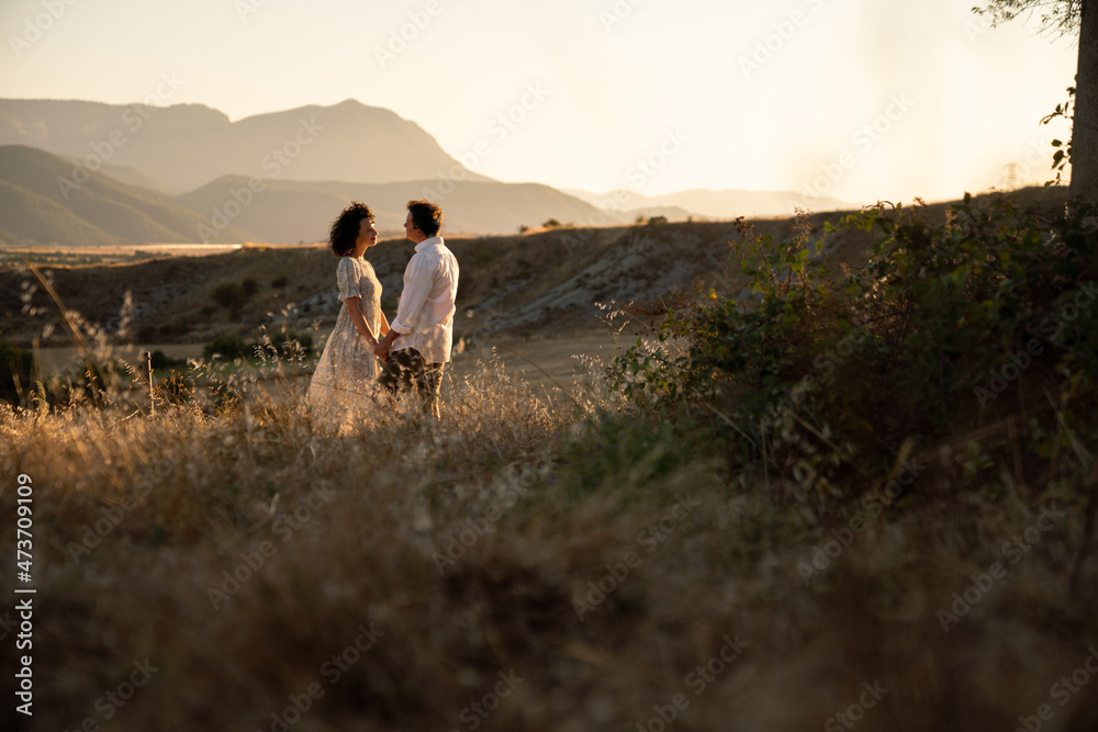 Lovely Couple In The Field At Sunset Stock Photo | Adobe Stock