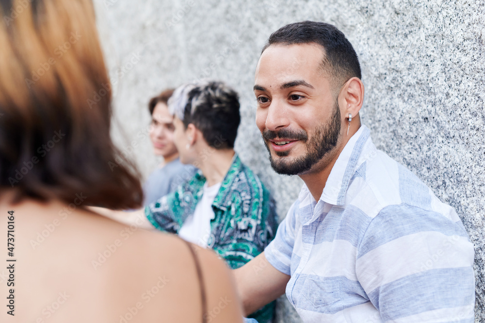 Lgbt friends talking while sitting outside Stock Photo | Adobe Stock