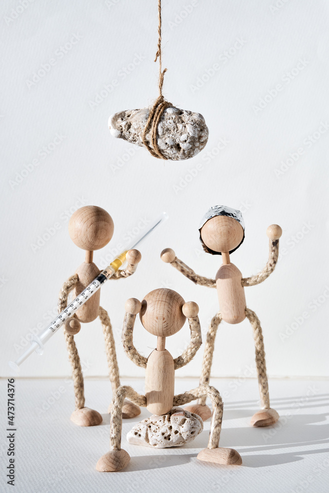 Dilemma of mandatory vaccination. Confused wooden toy man in fear of ...