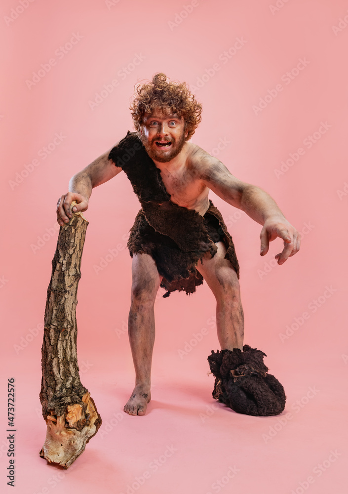 Full-length portrait of cheerful man in character of neanderthal ...