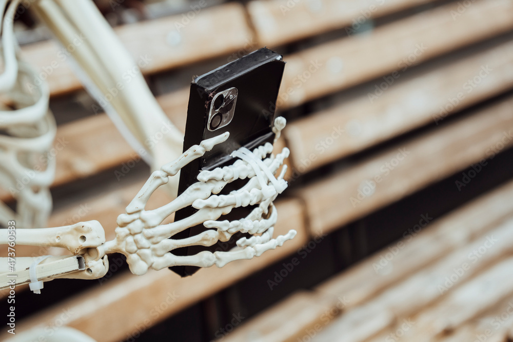 Halloween decoration near cafe or restaurant, modern skeletons sitting ...