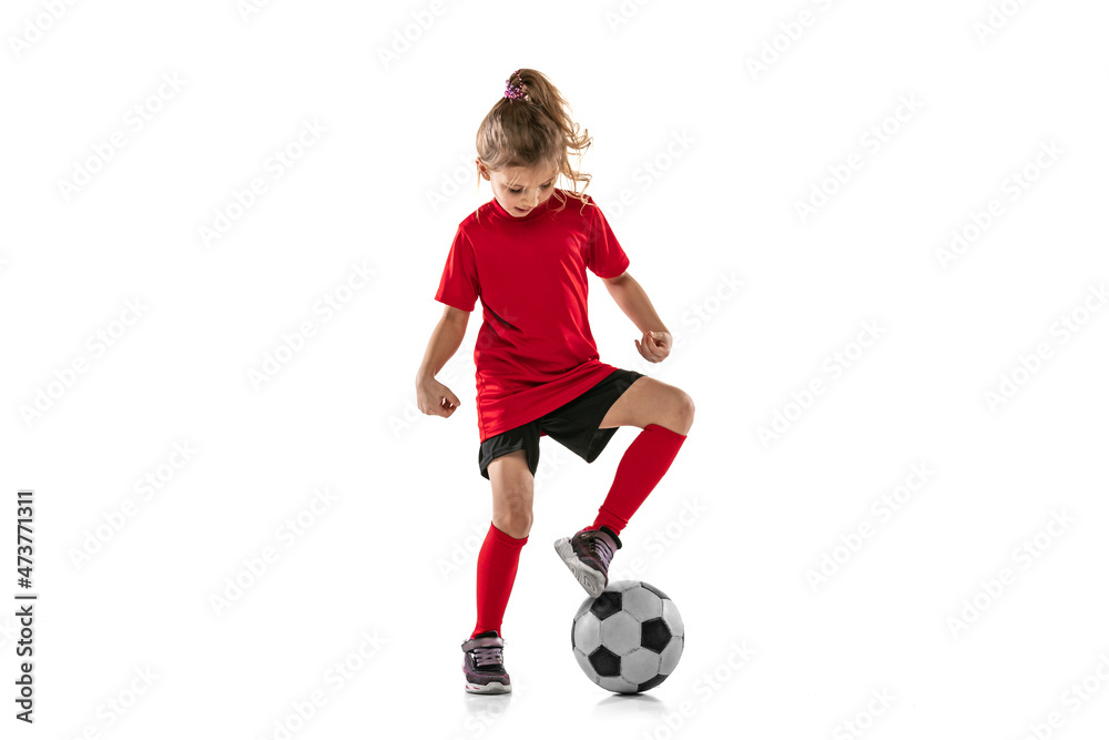 Full-length portrait of child, girl playing football isolated over ...