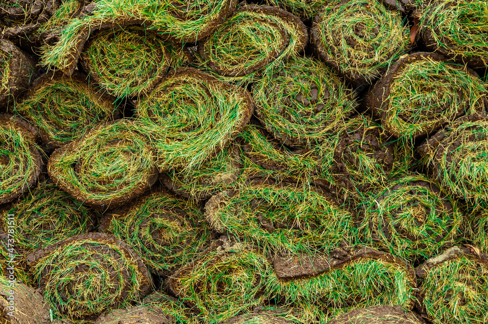 Stack of rolled turf for landscaping in city, parks and soccer fields ...