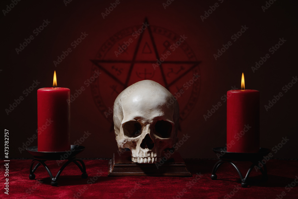 Pentagram symbol, human skull and candles. Black magic ritual or spell ...