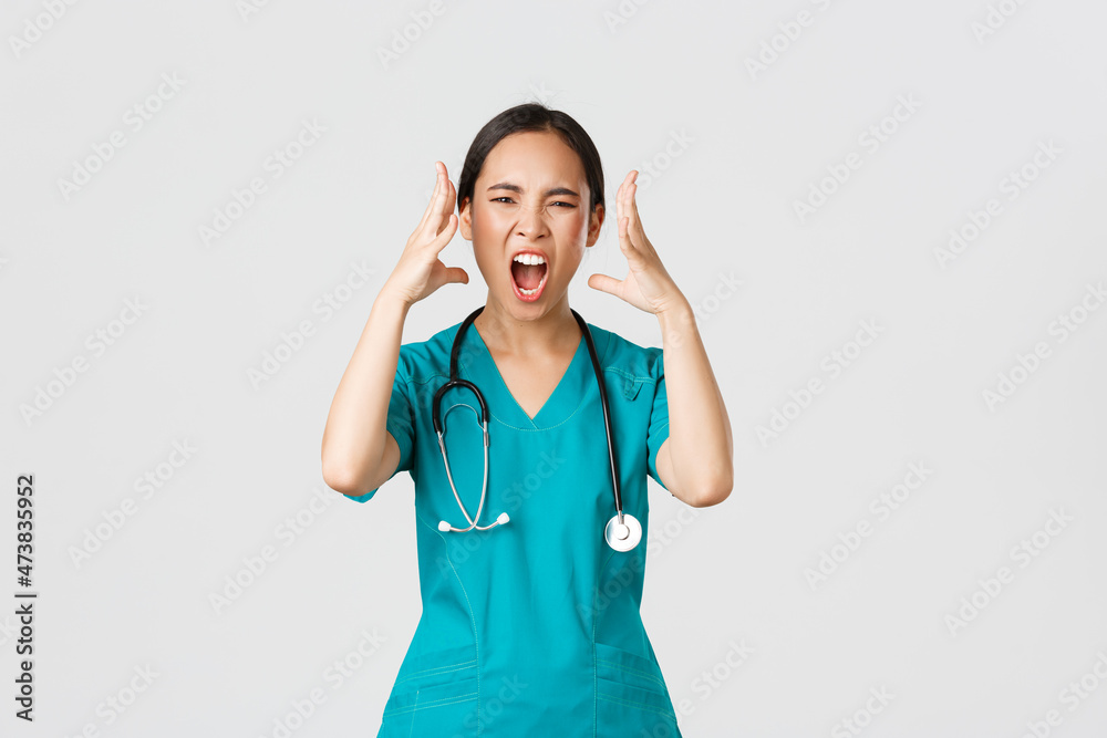 Covid-19, healthcare workers and preventing virus concept. Annoyed and ...