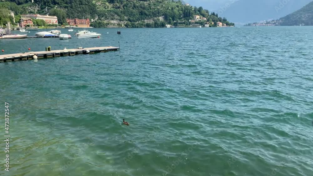Panoramic view of Lago di Como lake shore with houses on hills. Tiny ...