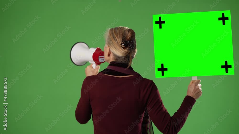 Woman facing away from camera holding green screen chroma key blank ...