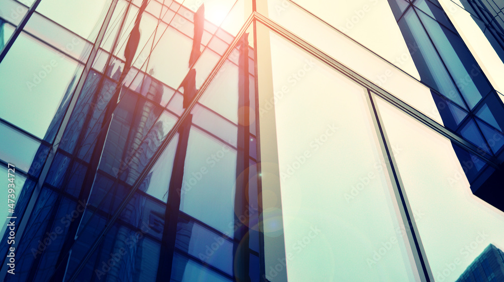 Modern office building with glass facade on a clear sky background ...