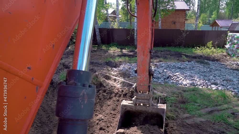 Excavation of the pit. The excavator digs up the soil at the ...