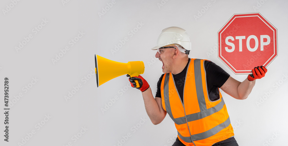 Builder yells at the megaphone. Person emotionally warns of danger ...