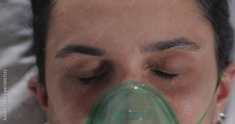 Extreme close-up of a young brunette woman opening her eyes in a ...