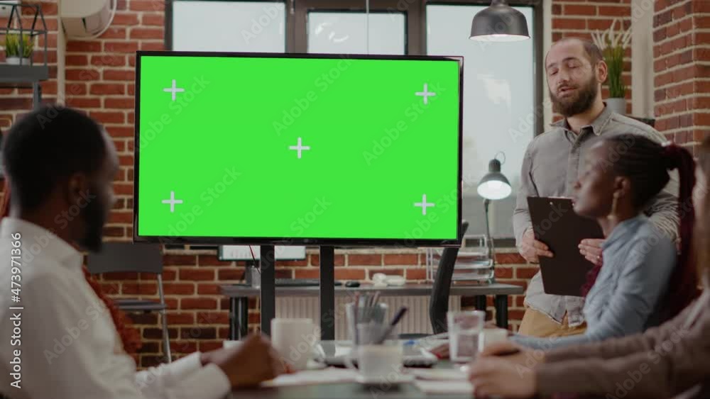 Workmates using monitor with mockup green screen in startup office ...