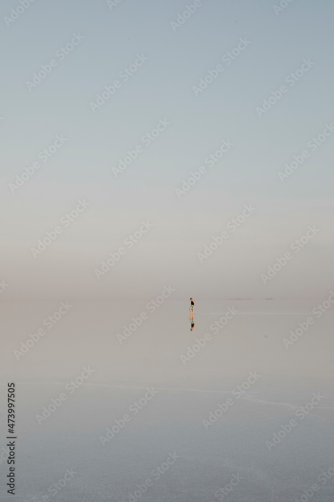 Distant view of woman standing at Lake Karum, Danakil Depression ...