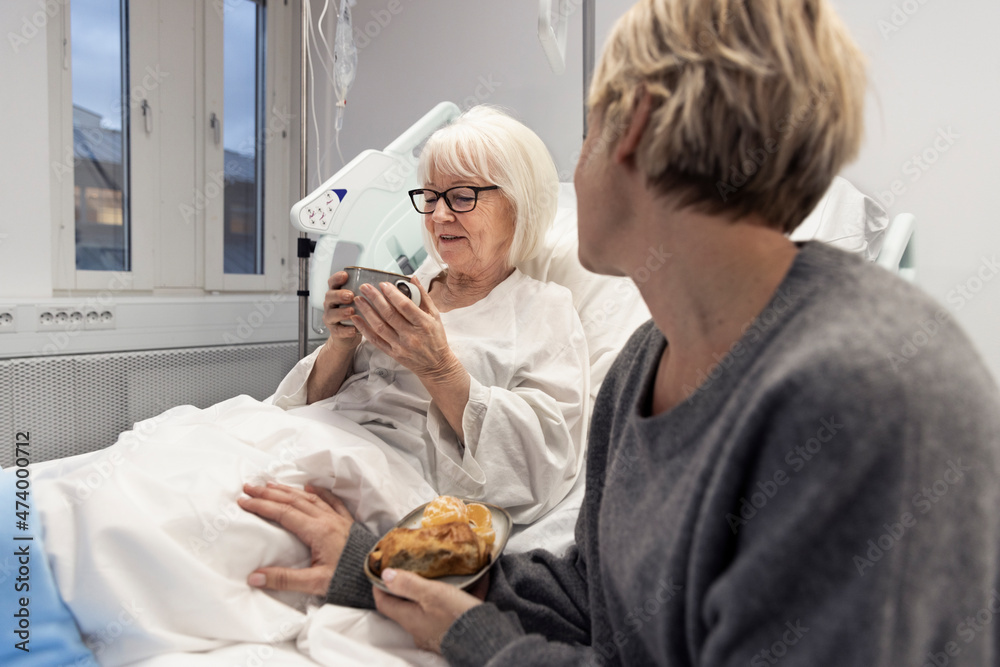 Adult daughter visiting mother in hospital Stock Photo | Adobe Stock