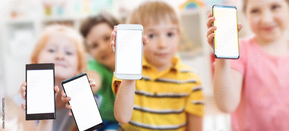 Group of children holding in their hands smartphones with mock-up ...