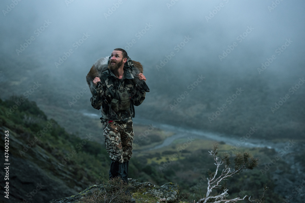 Hunter carrying dead mountain goat Stock Photo | Adobe Stock
