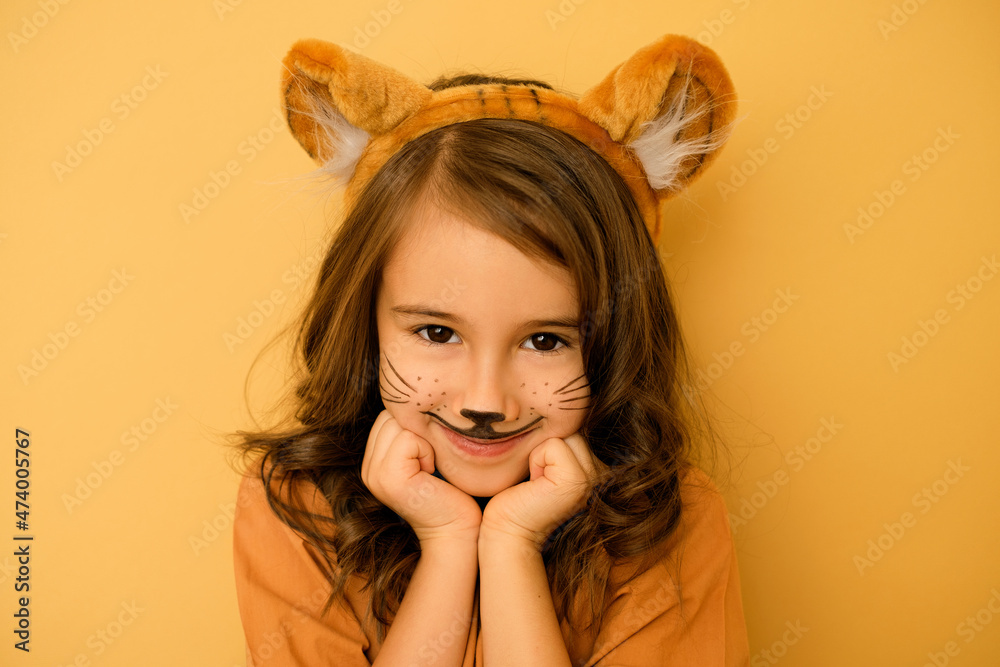 Сute girl with ears and a tiger mask pattern on face smile sweetly with ...