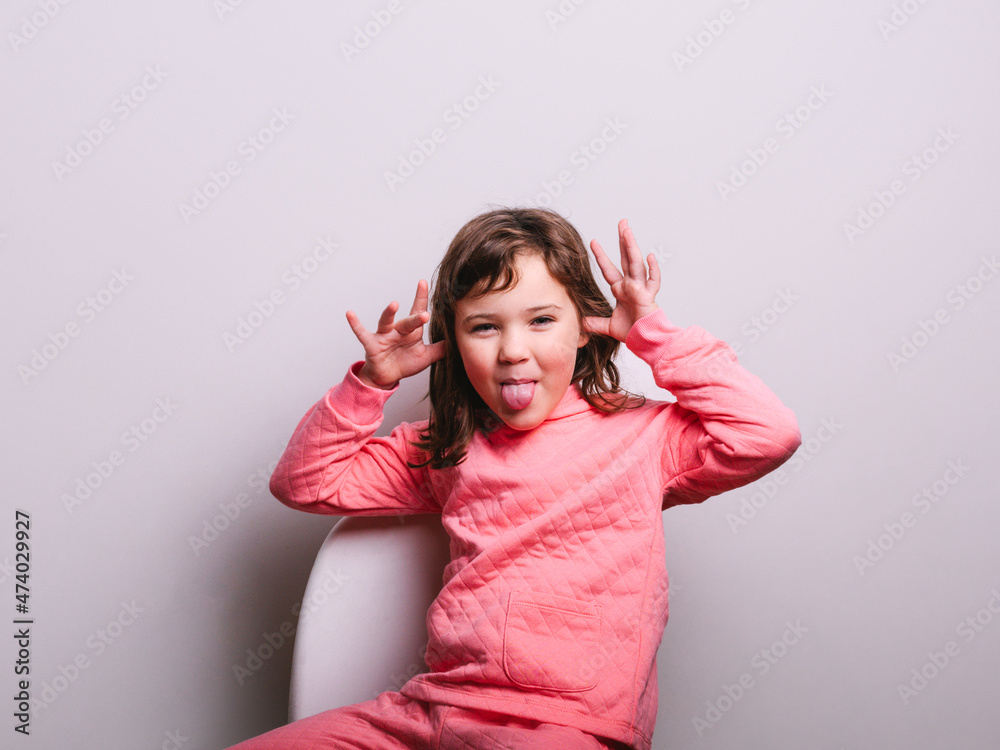 Funny little girl making face Stock Photo | Adobe Stock
