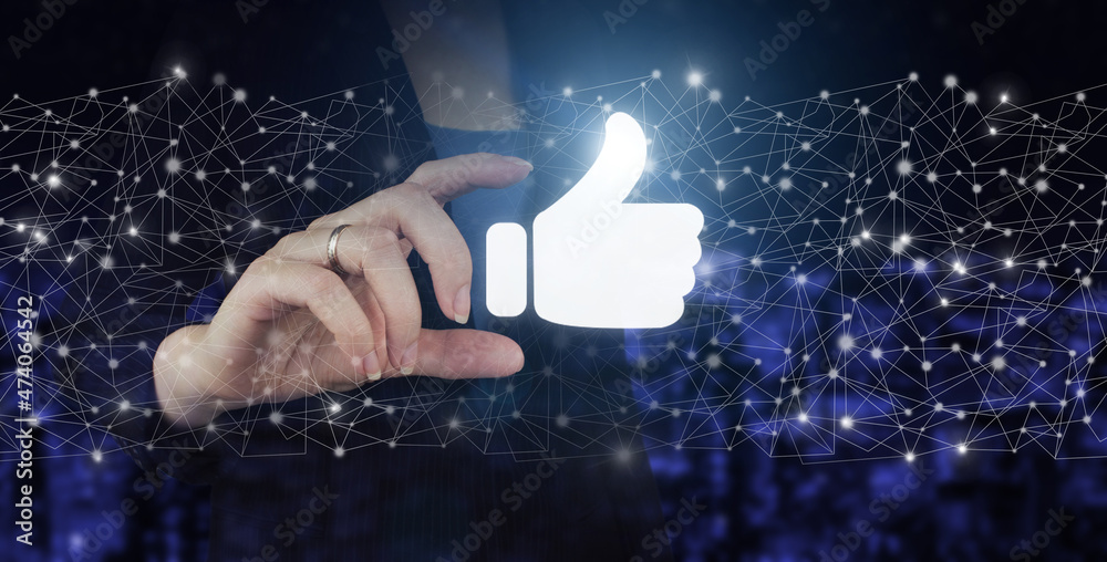 Tumb up concept. Hand hold digital hologram hand tumb up sign on city ...