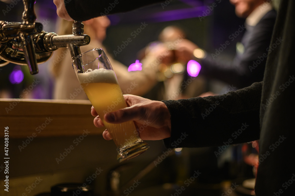 Hand of bartender using beer tap while working in a bar Stock Photo ...