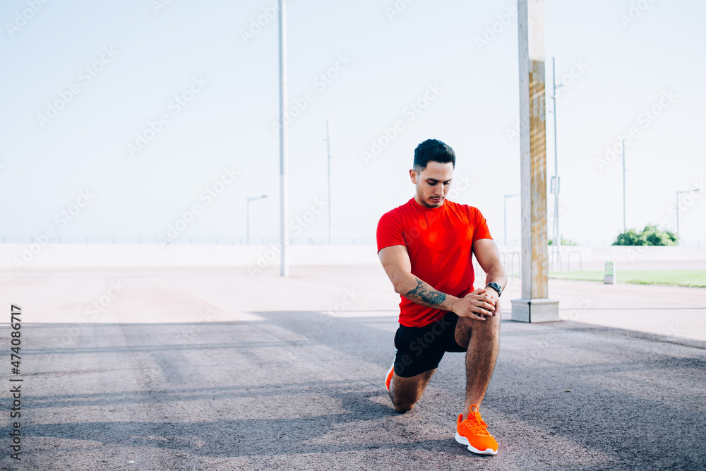 Determined Male Athlete Doing Squats Stretching Legs Enjoying Physical