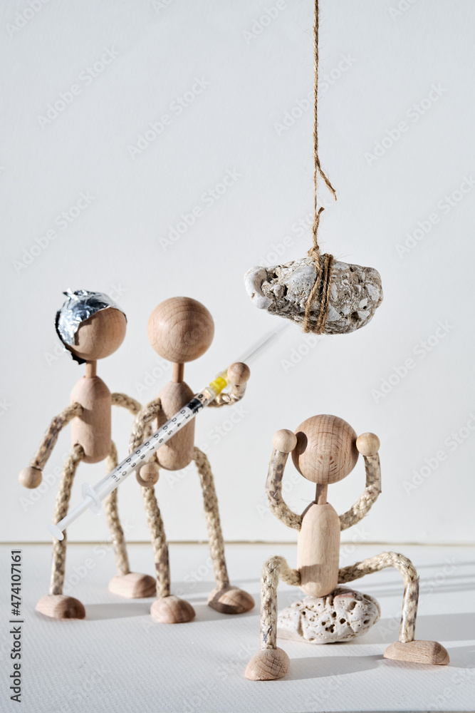 Dilemma of mandatory vaccination. Confused wooden toy man in fear of ...