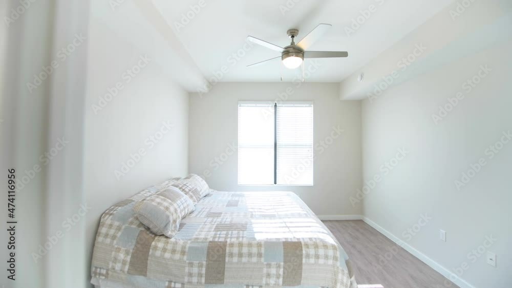 Walking point of view inside empty bedroom room interior with bed ...