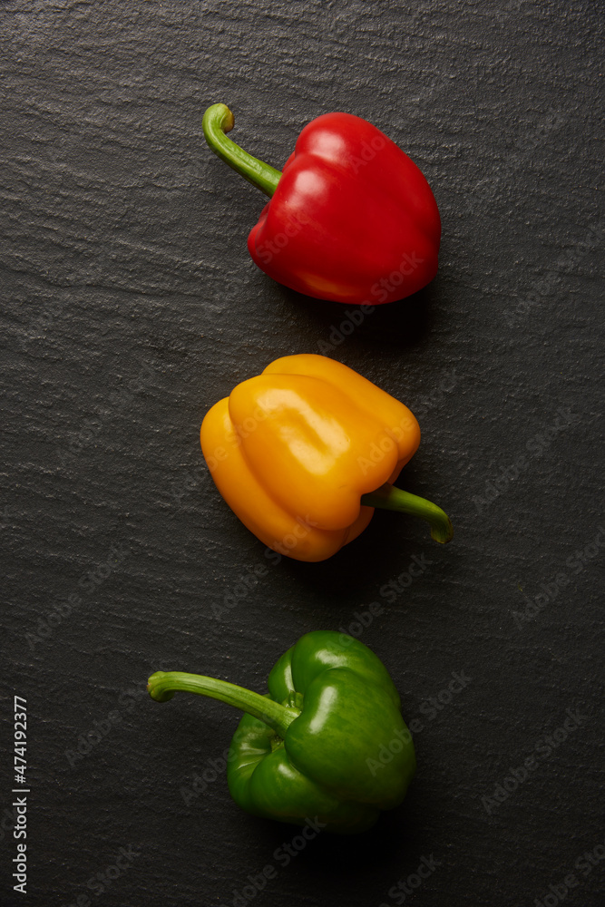 vegetable concept three different colors of bell peppers lying on the ...