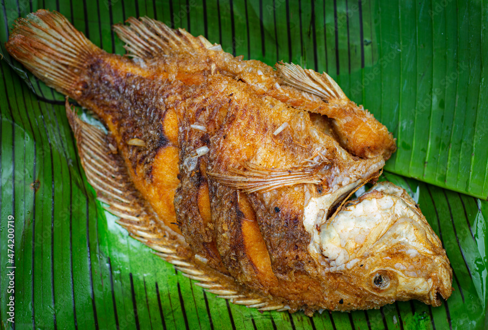 Close up top view shot of tilapia fish deep fried and displayed on ...