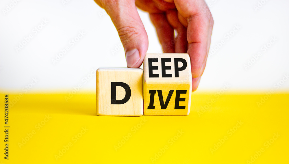 Deep dive symbol. Businessman turns a wooden cube with words 'Deep dive ...