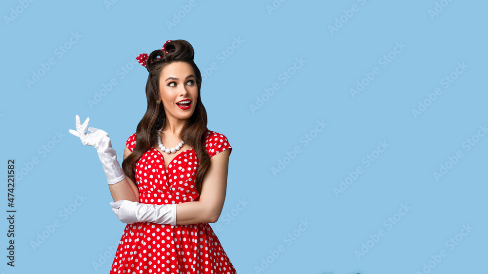 Beautiful young pinup woman in retro vintage outfit looking aside at ...