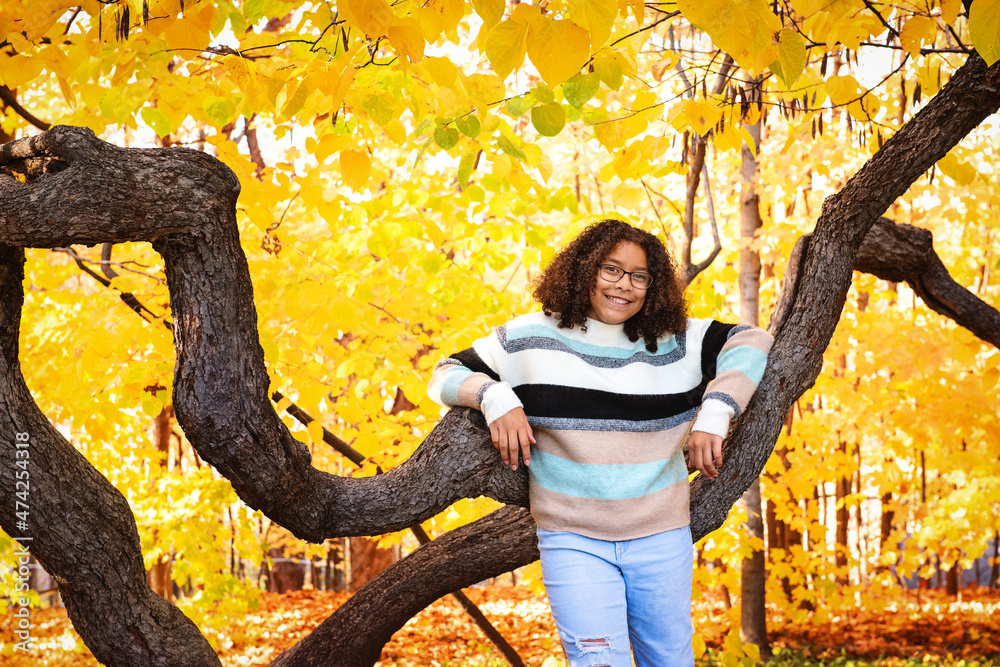 Pretty tween girl in sweater by a tree outdoors in fall colors. Stock ...